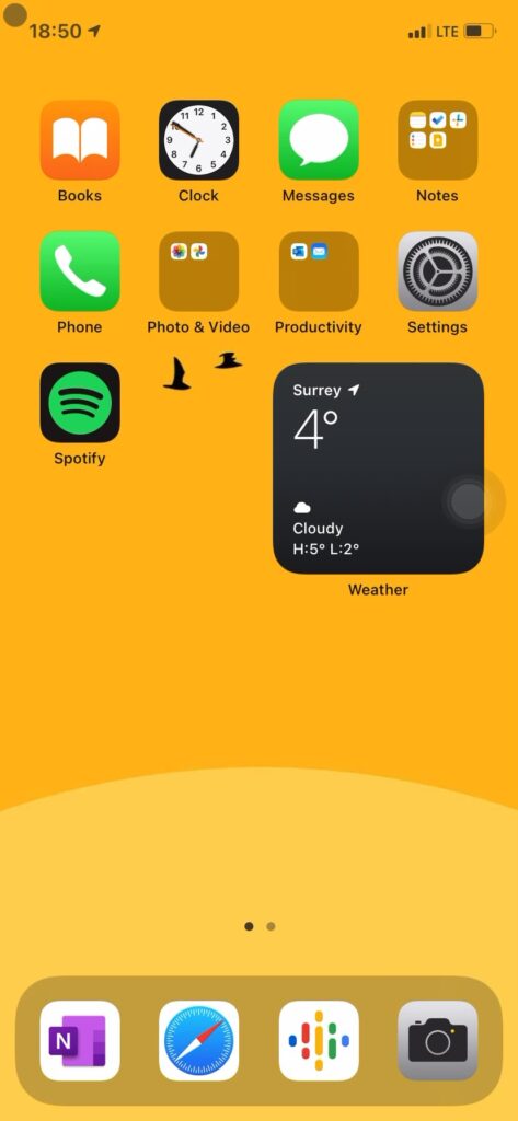 Why does an orange dot appear on my iPhone when I make a call?